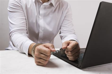 Premium Photo Hacker In Handcuffs Near Laptop Concept Of Computer Crimes