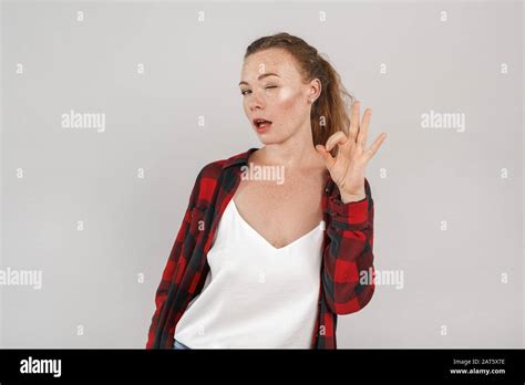 Freestyle Young Woman With Freckles Standing Isolated On Grey Showing