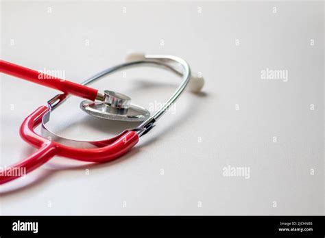 Red Stethoscope In Doctors Office For Professional Cardio Checkup And Healthy Heartbeat Pulse