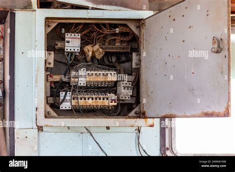 Old Rusty Circuit Breaker Box With Switches And Cable Wiring Inside