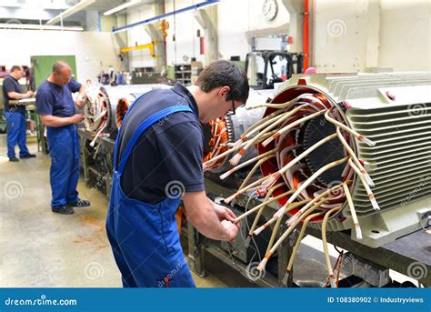 Workers In A Factory Assemble Electric Motors Editorial Photography