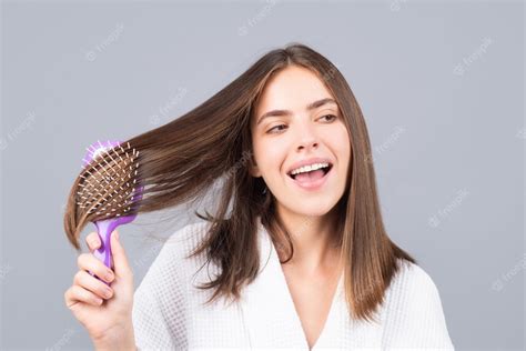 Premium Photo Amazed Woman Combing Hair Portrait Of Female Model With