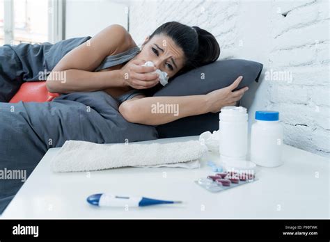 Sick Hispanic Woman In Bed Calling In Sick Day Off From Work