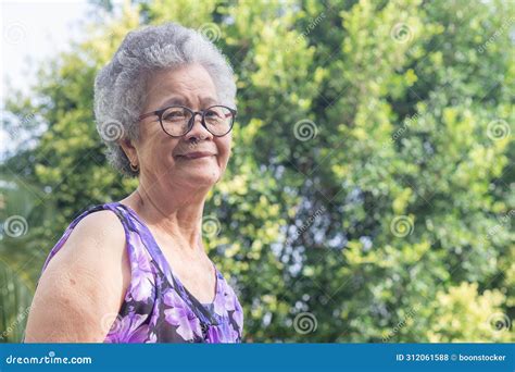 Portrait Of A Senior Woman With Short Gray Hair Wearing Glasses