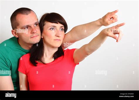 Serious Woman And Man Looking And Pointing Into Distance Married Pointing With Finger At