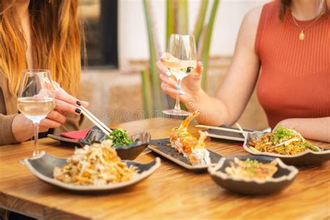 Two Girls Eating In A Sushi Restaurant In Summer Stock Image Image Of