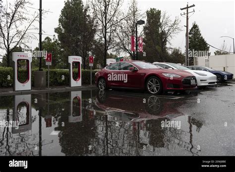 Tesla Logo Is Seen On A Supercharger Electric Vehicle Charging Station In Mountain View