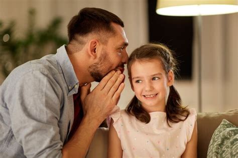 Premium Photo Happy Father Whispering Secret To Daughter At Home