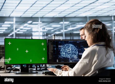 woman in ai data center coding on green screen computers upgrading