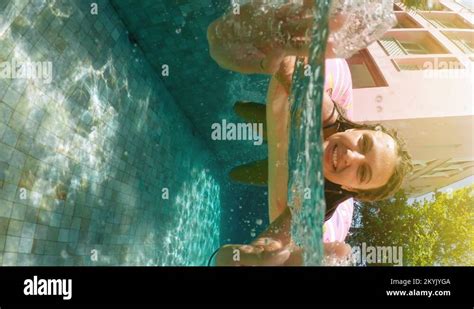 Woman With Sunglasses In Blue Bikini Lying In Inflatable Pink Donut