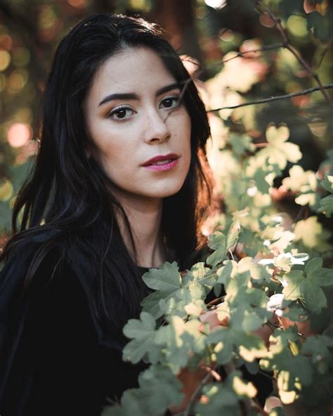 Premium Photo Close Up Portrait Of Young Woman Standing By Tree