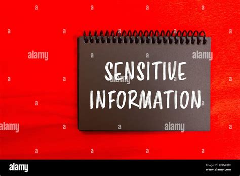 Sensitive Information Message Written On Black Notebook Page With Red
