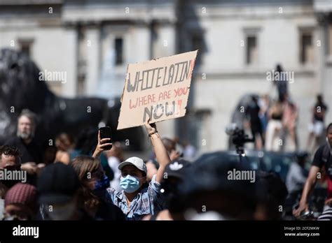 A Woman Holds A Sign Calling For The Support Of White Latinx In The Black Lives Matter Movement