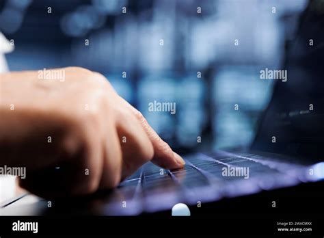 Cloud Computing Company Executive Using Laptop To Examine Server Racks