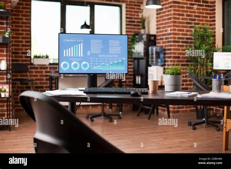 Empty Brick Wall Workspace Showing Business Data Analytics On Desktop Monitor Well Organized