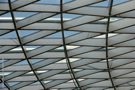 An Upward View Of A Modern Geometric Glass Roof Construction Featuring A Complex Network Of
