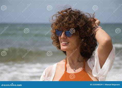 Retrato De Atractiva Mujer Madura Con Gafas De Sol De Pelo Rizado Y Bikini Posando En La Playa