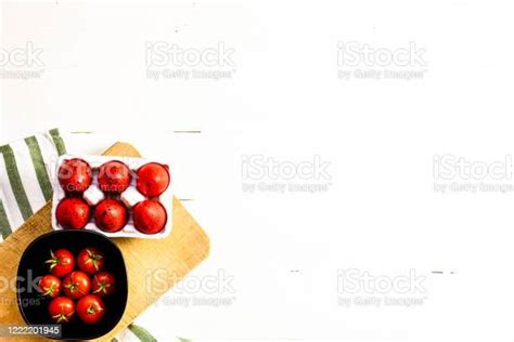 소박한 흰색 나무 테이블에 신선한 잘 익은 체리 토마토와 붉은 부활절 달걀의 상단보기 재료 및 식품 컨셉 건강한 생활방식에 대한