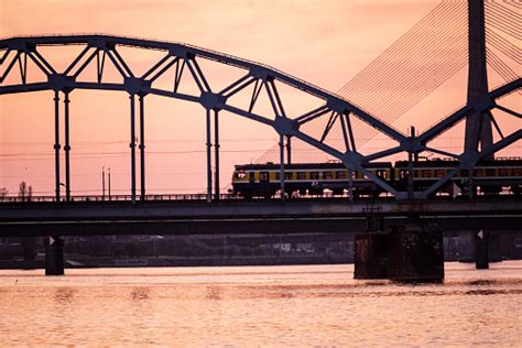 강의 Daugava 리가 라트비아에서 어두운 빨간색 Sunet에 걸쳐 철도 금속 다리 실루엣 강에 대한 스톡 사진 및 기타