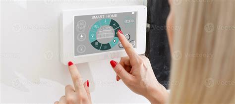 Woman Use Application For Smart Home Control On Tablet Interior Of