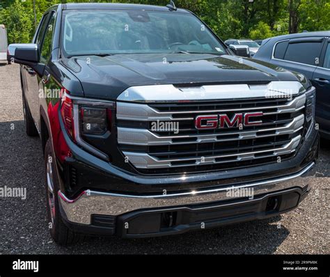 A Used Black Gmc Four Door Pick Up Truck For Sale At A Dealership In