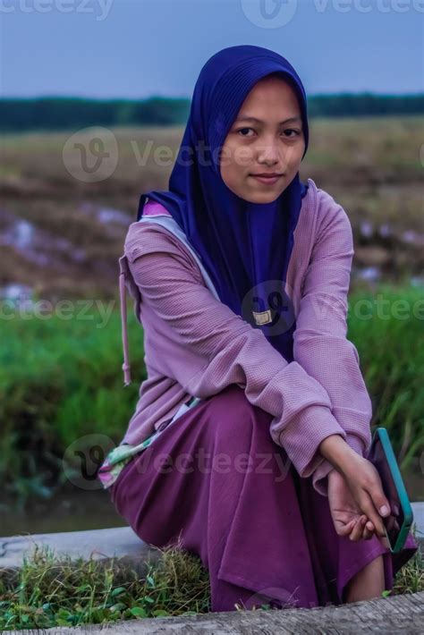 Muslim Woman Is Sitting On The Edge Of A Rice Field With Her Hands Together Rice Fields