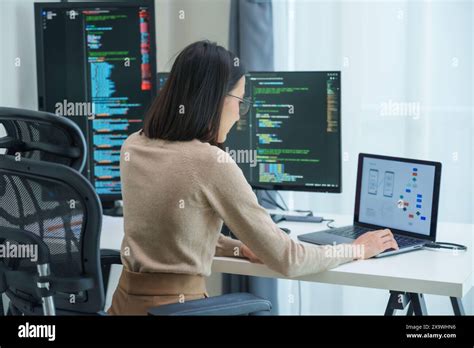 Asian Prompt Engineer Develop Coding App With Software Data Sitting In