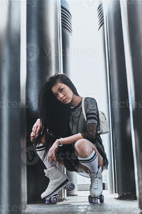 Great Look Beautiful Young Woman In Rollers Looking At Camera While