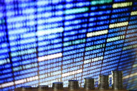 Premium Photo Stacked Coins Against Binary Code On Screen