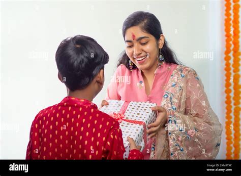Brother Giving T To His Sister On The Occasion Of Raksha Bandhan