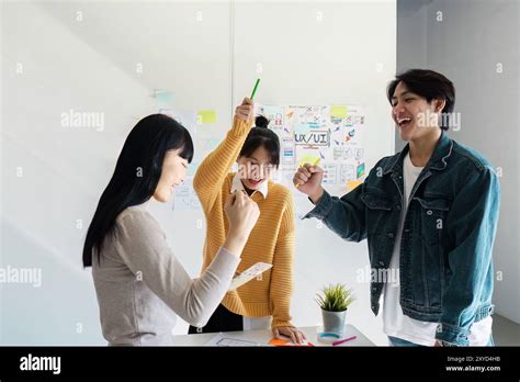 Creative Team Collaborating On Ux Ui Design Project In Modern Office