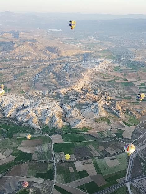 Premium Photo Aerial View Of Hot Air Balloon Flying Over Landscape