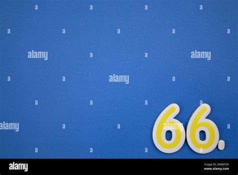 The Number 66 In Yellow Photographed From Above Placed On The Edge Of