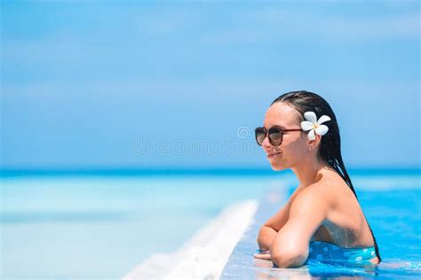 Young Beautiful Woman Enjoying Summer Vacation In Luxury Swimming Pool