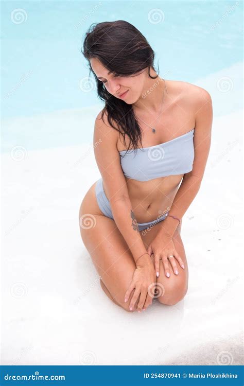 Beautiful Tanned Sporty Slim Woman Relaxing In White Swimming Pool With Amazing Blue Water