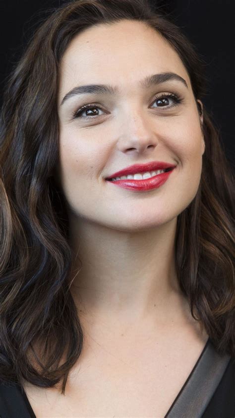 A Close Up Of A Person Wearing A Black Shirt And Red Lipstick With Long