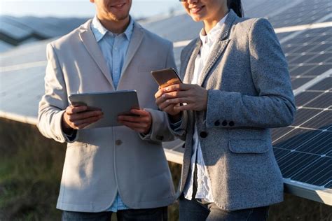 Premium Photo Unrecognized Woman And Man Engineers Showing Photovoltaic Project On The Tablet