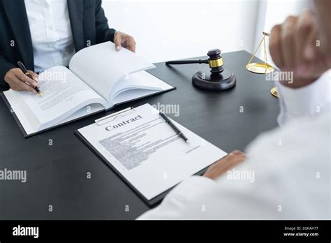 Law Libra Scale And Hammer On The Table 2 Lawyers Are Discussing About