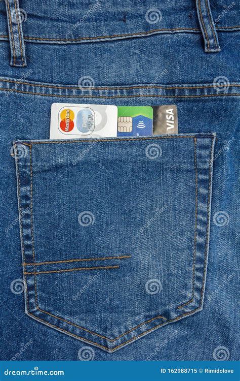Close Up View To Credit And Debit Cards Sticking Out From A Blue Jeans