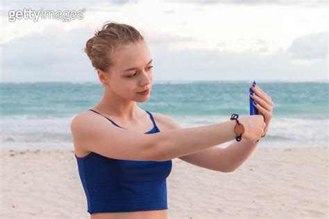 Beautiful Blond Girl Takes Selfie Photo On Her Smartphone On The Beach