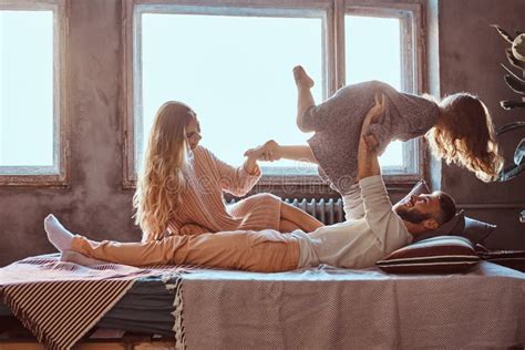 Mom Dad And Babe In Bed Father Playing With Adorable Babe In Bedroom Stock Image