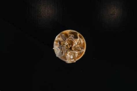 Premium Photo Iced Coffee Latte On A Table With Cream Being Poured