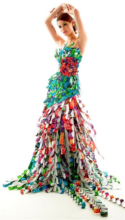 A Woman In A Long Dress Made Out Of Ribbons And Plastic Cups Is Posing