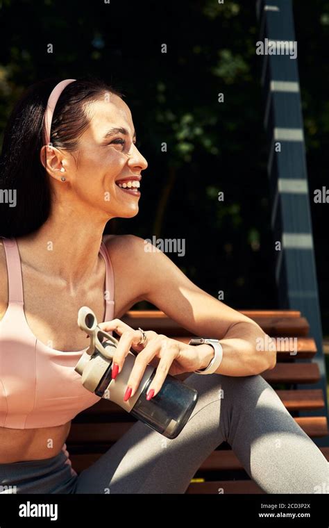 Confident Beautiful Woman Resting After Workout Outdoor And Drinks