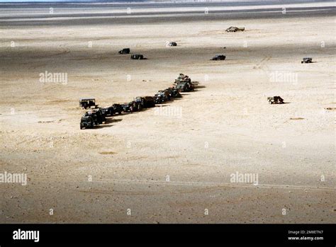A Convoy Of U S Military Vehicles Arrives At A Staging Area During