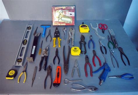 Hand Tool Assortment Including Linemans Plyers Tin Snips Plyers Tape