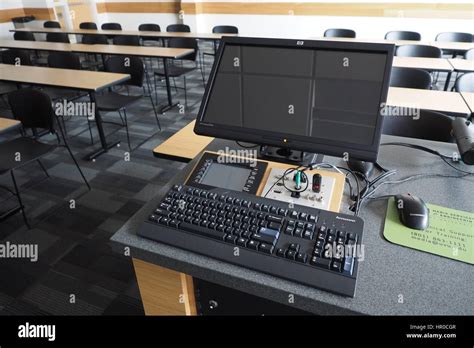 Professors Lectern Or Desk At Front Of Classroom With Computer And