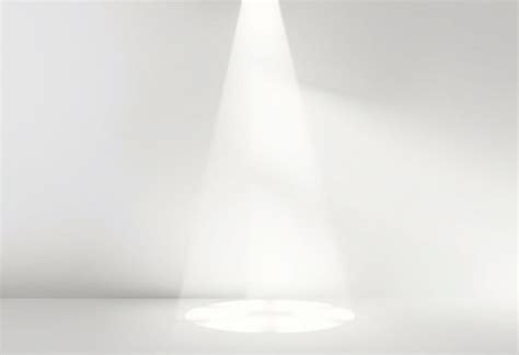 A Spotlight Shining Down On A White Floor Casting A Circular Beam Of Light Premium Ai