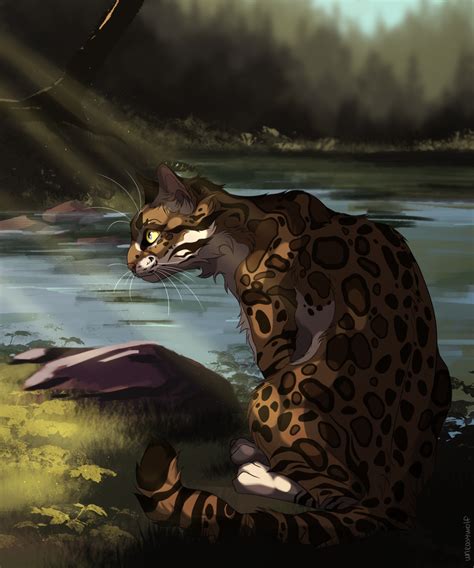 A Cat Sitting On The Ground Next To A Body Of Water
