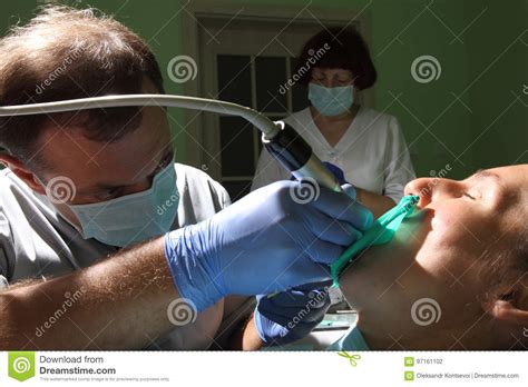 Dentist Treating A Patient`s Teeth With Dental Tools In Dental Clinic